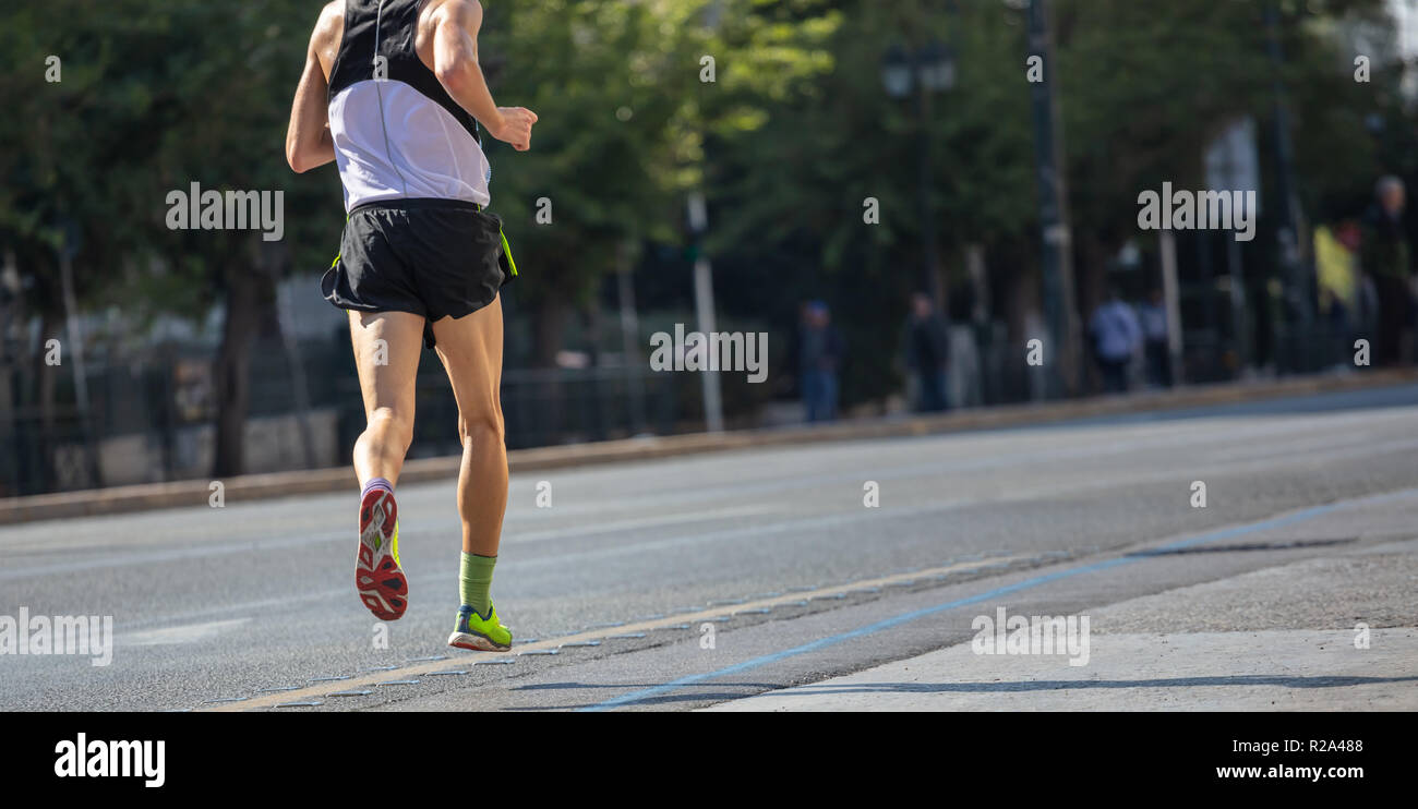 Running in the city roads. Young man runner, back view, banner, blur ...