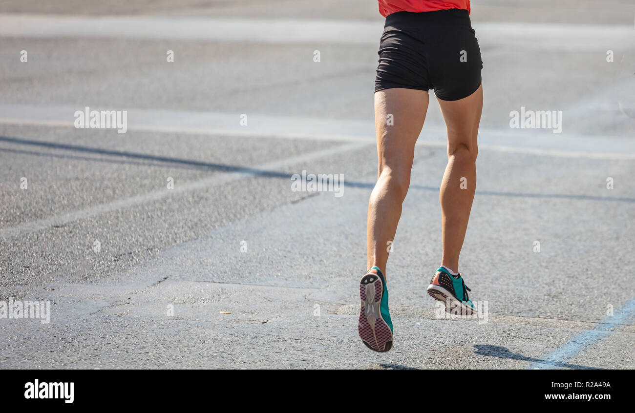 Running in the city roads. Young man runner, back view, blur background ...