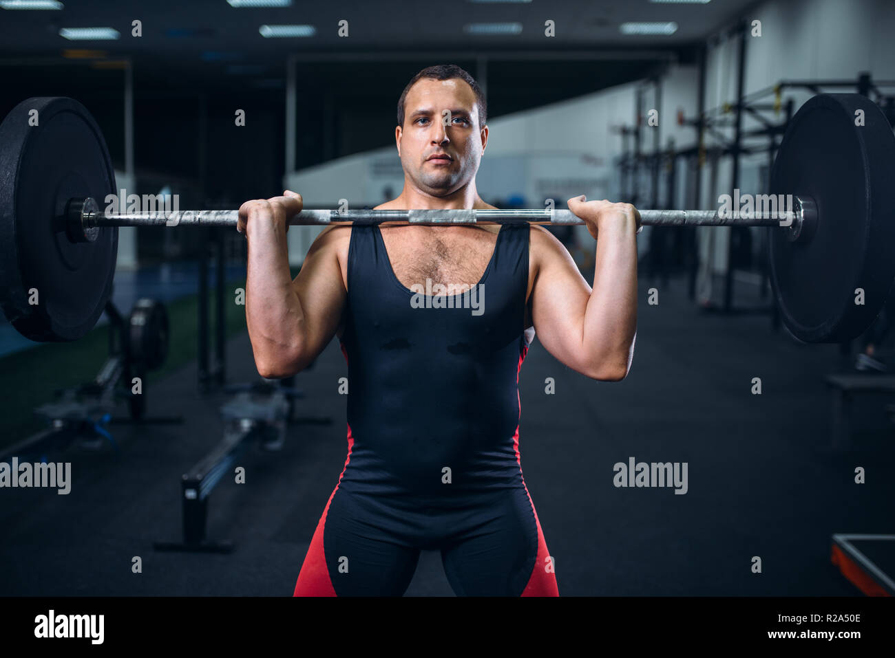 Male powerlifter preparing deadlift a barbell in gym. Weightlifting ...
