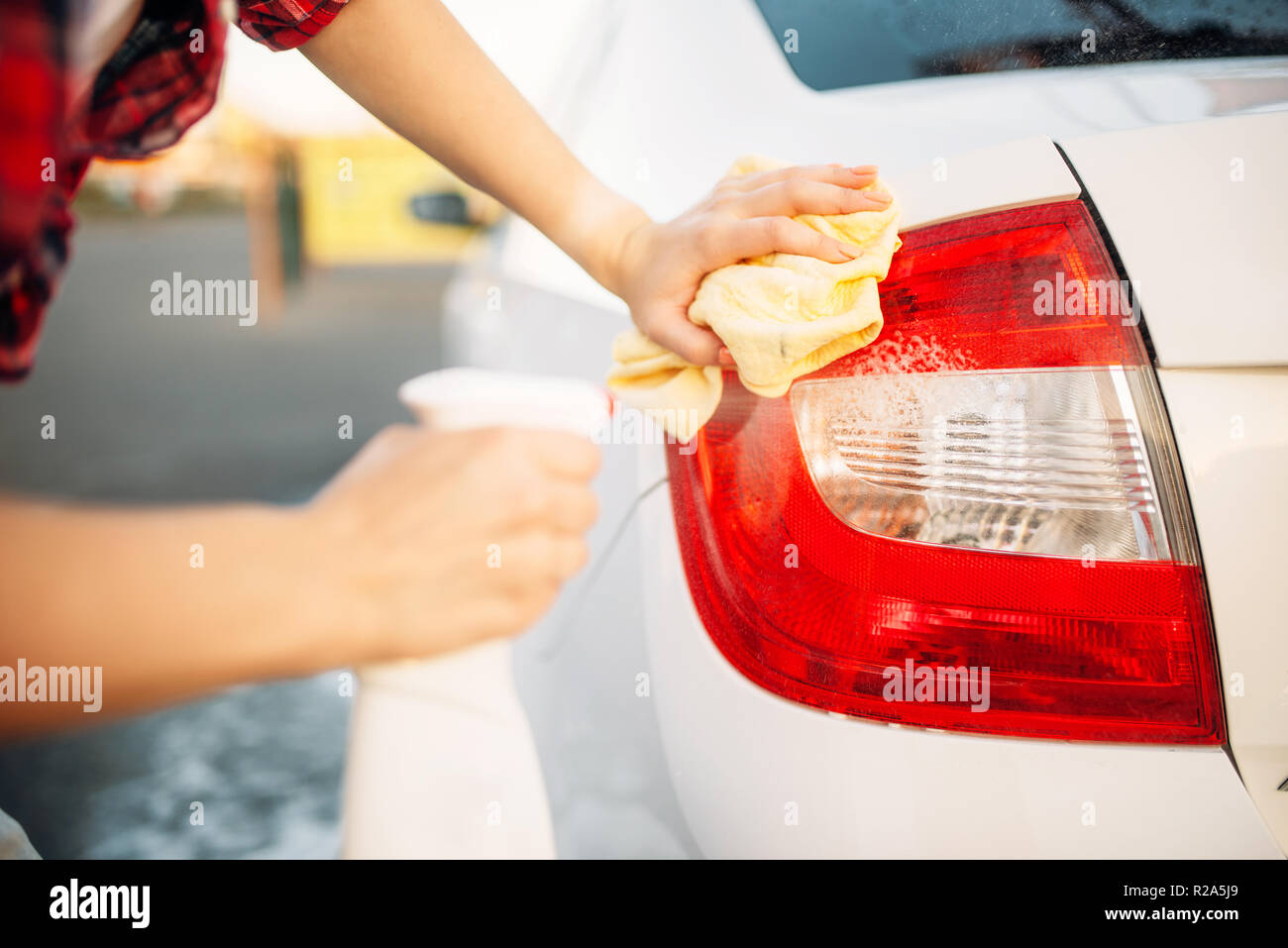 Woman cleans rear lights car hi-res stock photography and images - Alamy