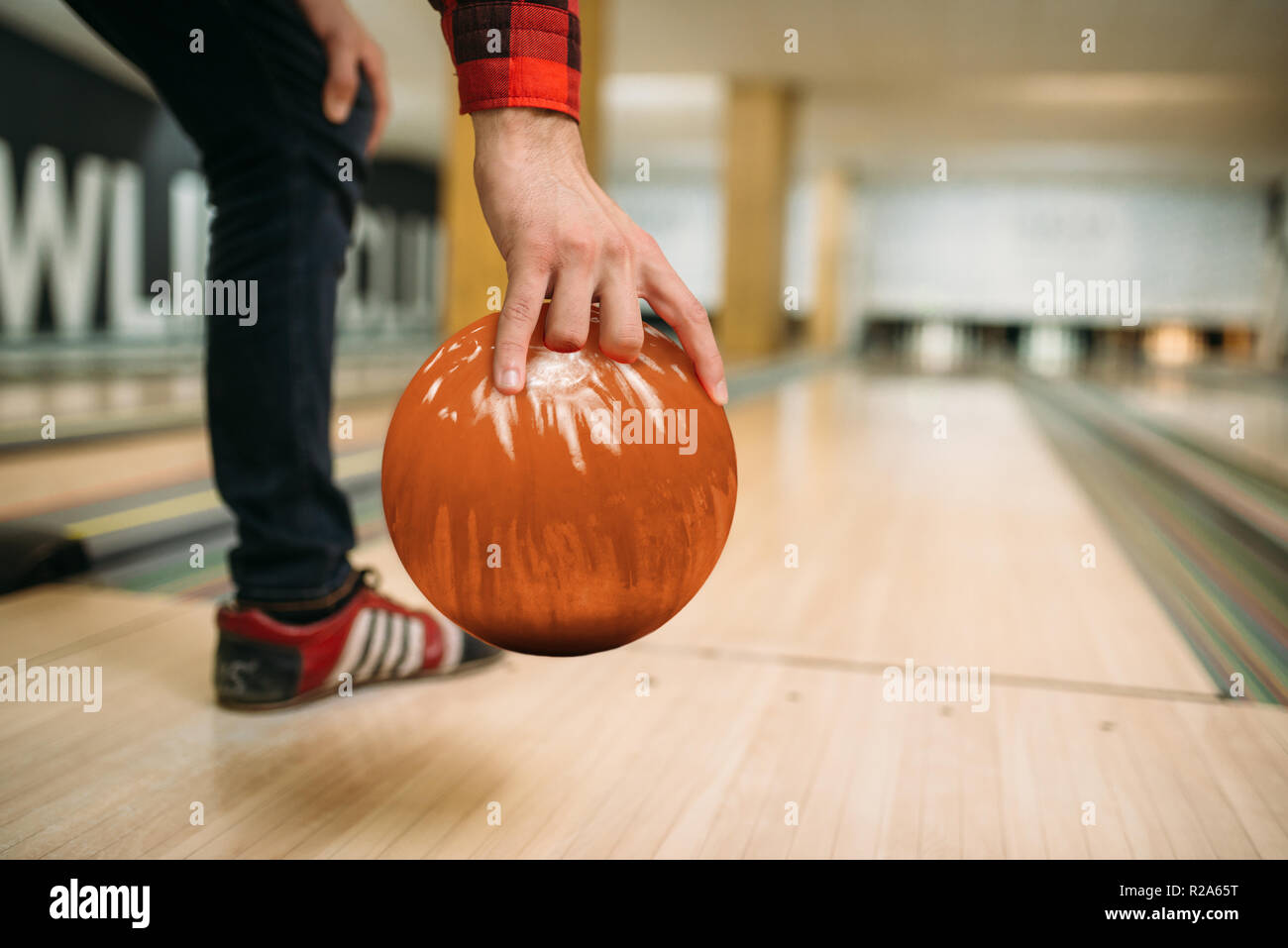 Male bowler makes throw, closeup view on hand with ball. Bowling alley ...