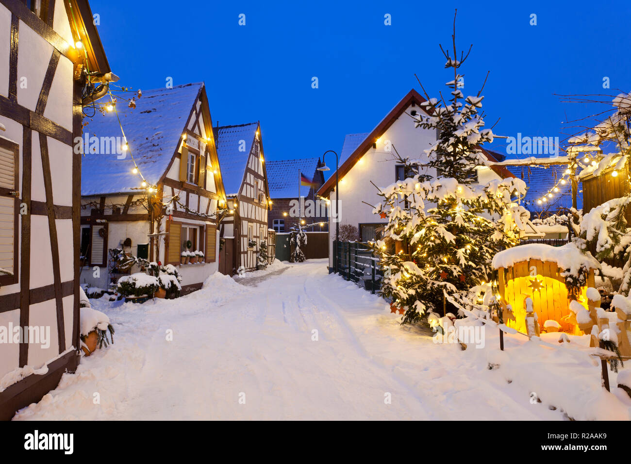 An old street with half-timbered houses and christmas lights at night ...