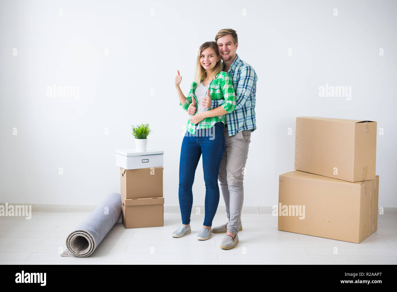 Relocation, new home and real estate concept - Young couple upacking in ...