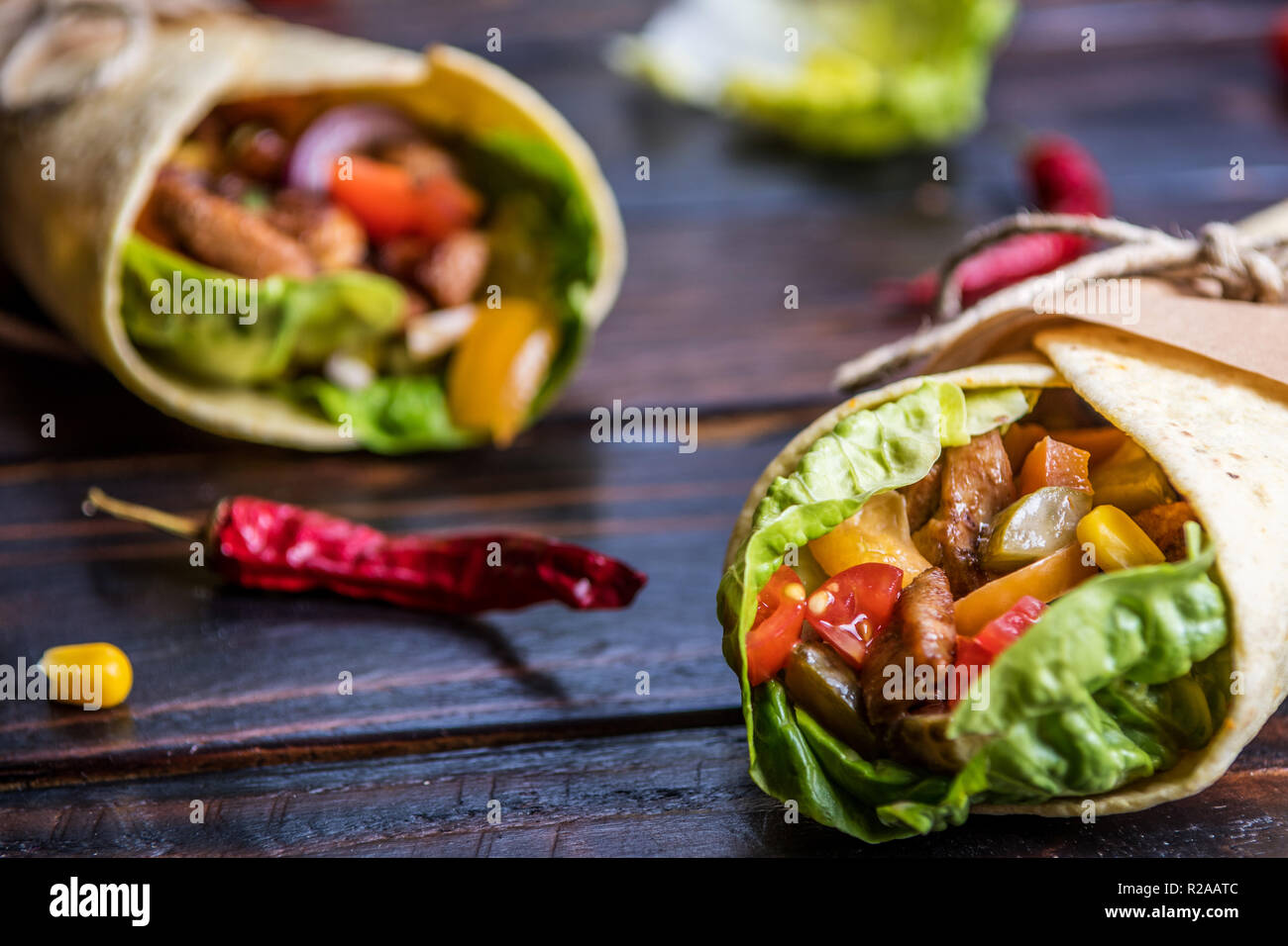 Traditional mexican tortilla wrap with vegetables and grilled chicken ...