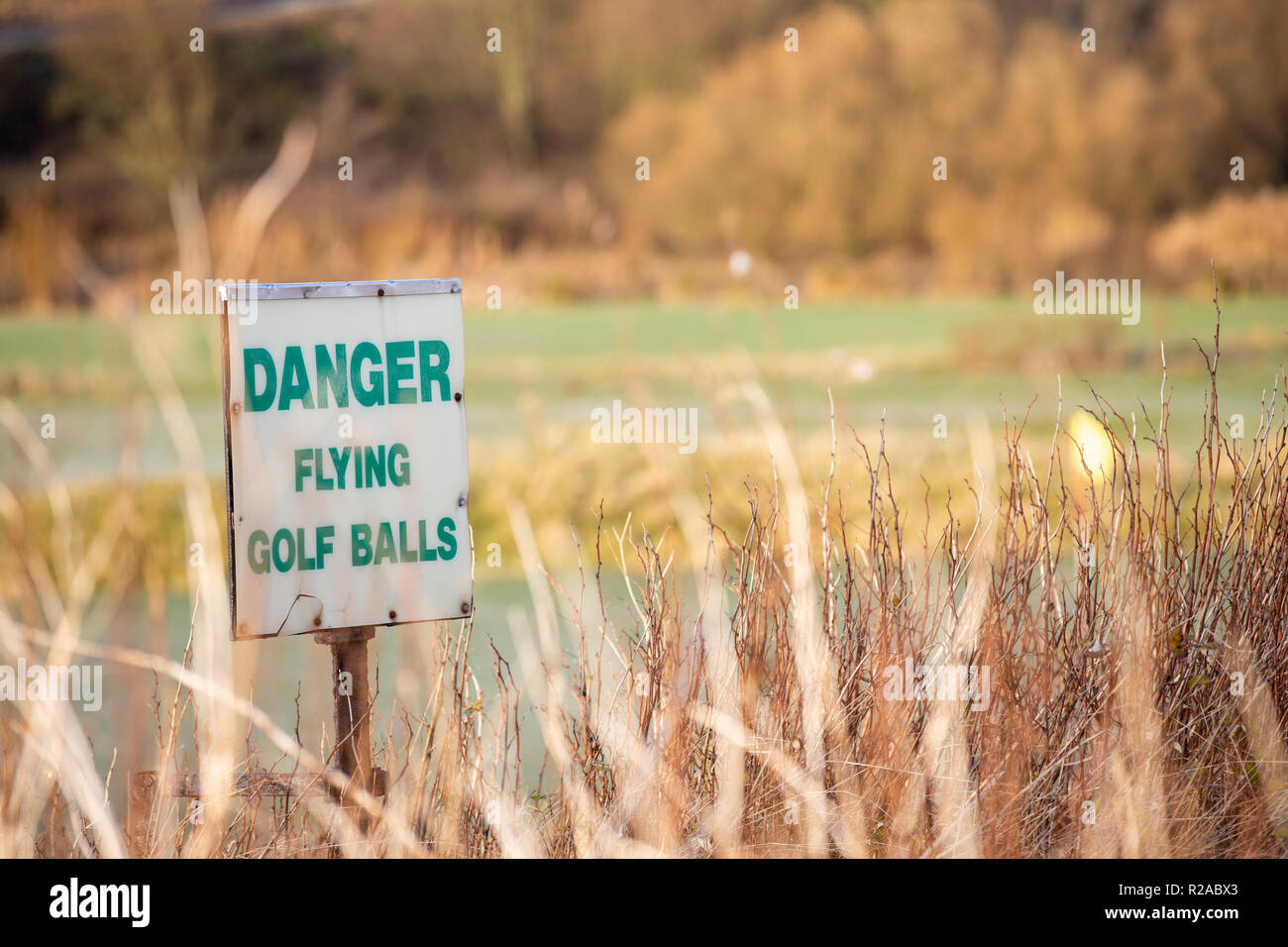 Danger flying golf balls sign Stock Photo - Alamy
