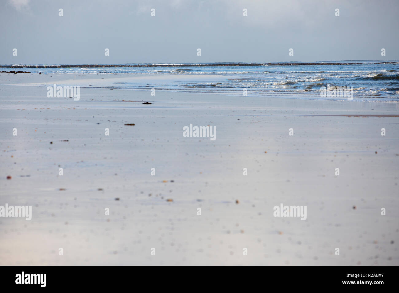 Cold winters day at the beach. Low tide with blue reflection Stock ...