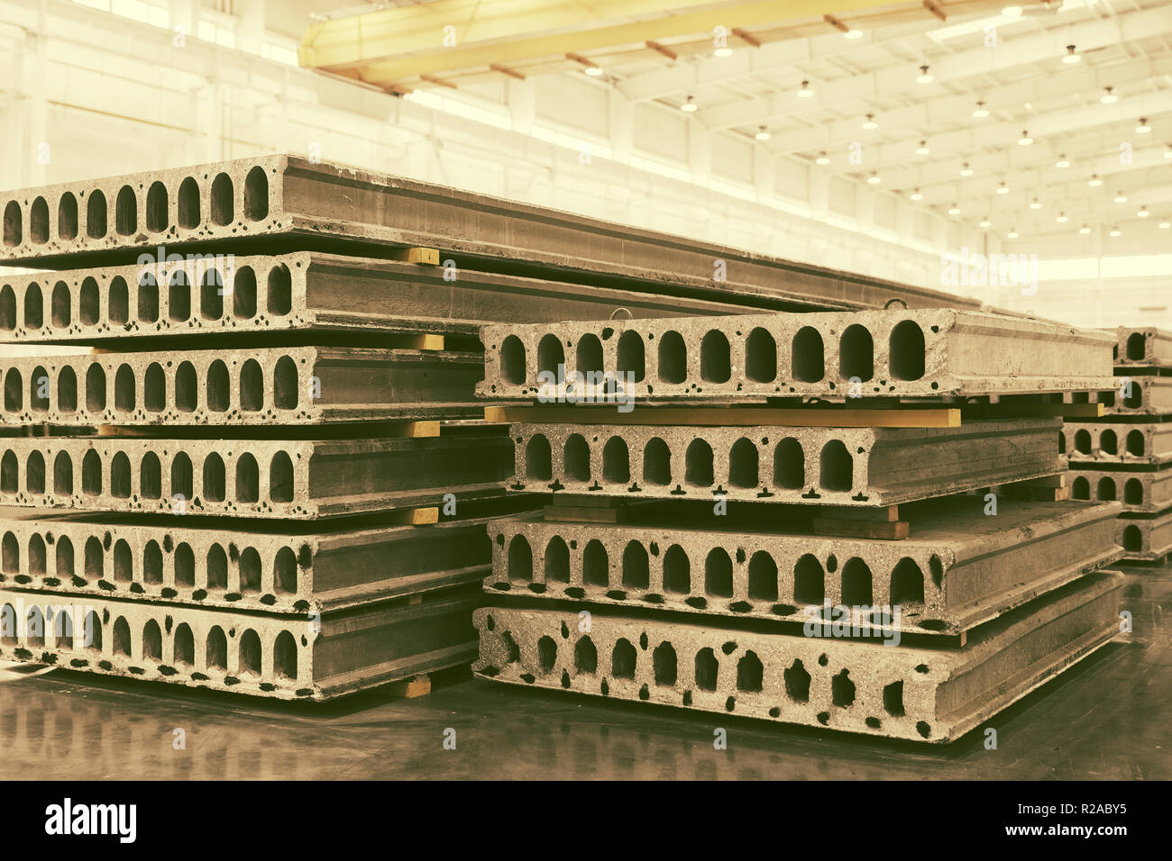 Stack of precast reinforced concrete slabs in a house-building factory ...