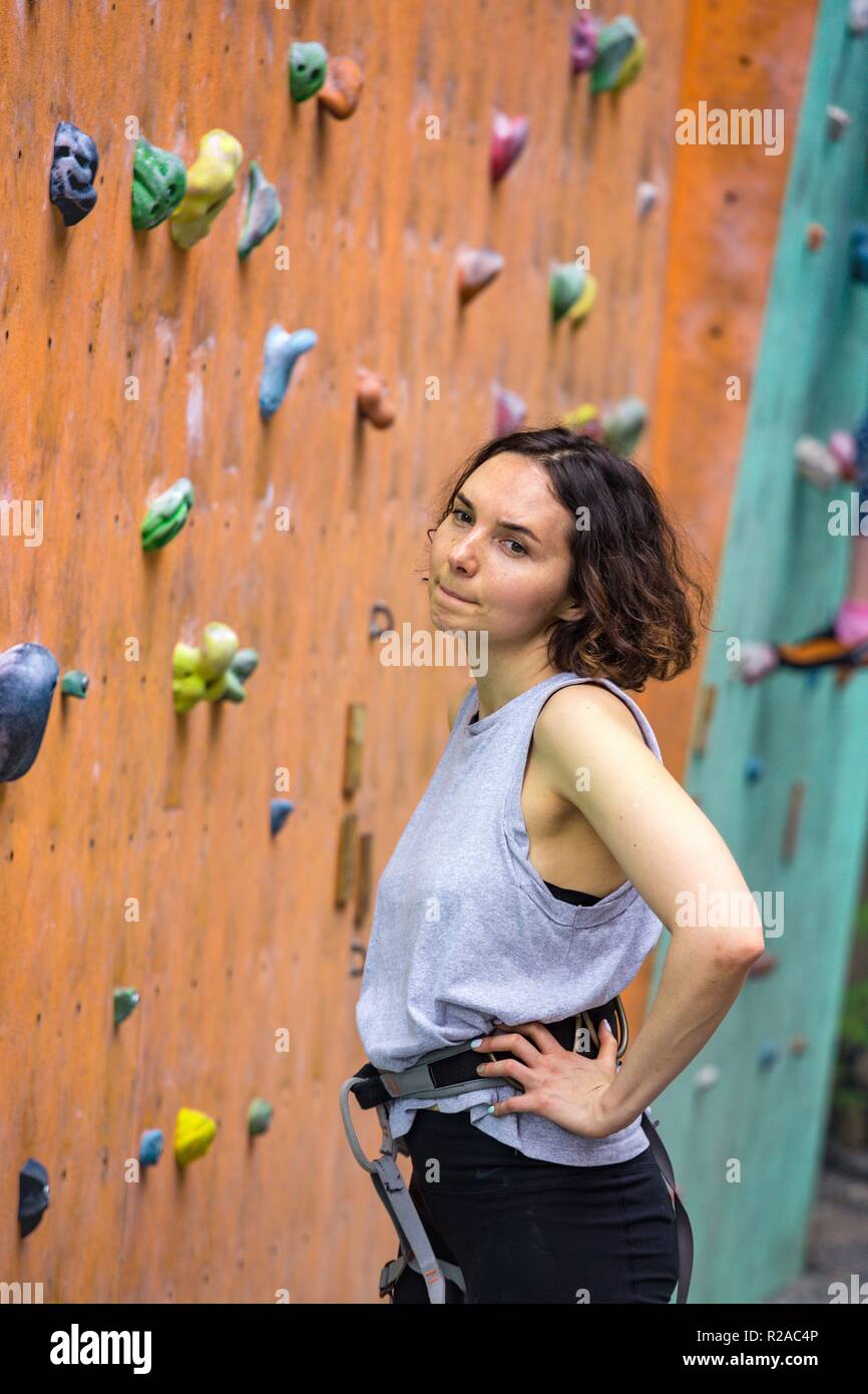 Bouldering, beautiful girl look on the climbing wall. Assessment of ...