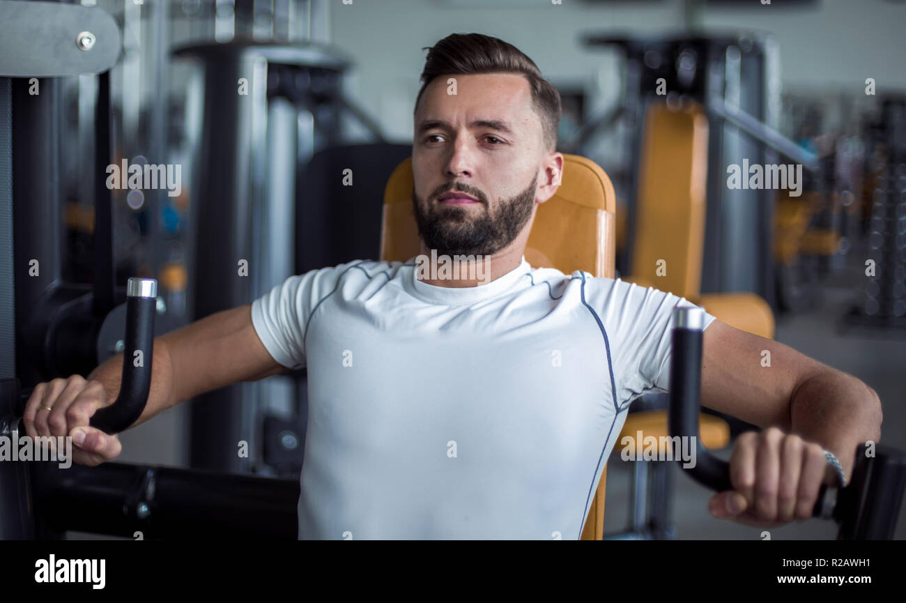 young man does weight training in the gym Stock Photo - Alamy