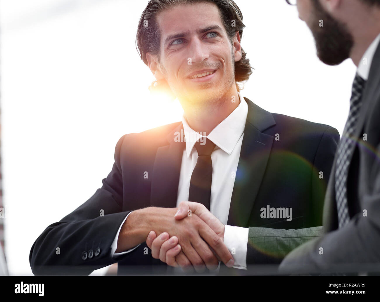 confident handshake colleagues in the office Stock Photo - Alamy