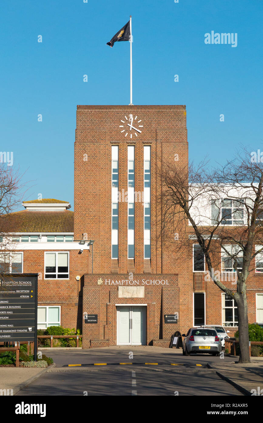 Front exterior facade of Hampton School with flag flying. It is an ...