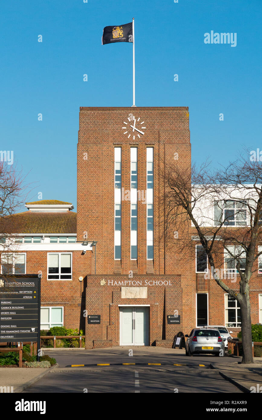 Front exterior facade of Hampton School with flag flying. It is an ...