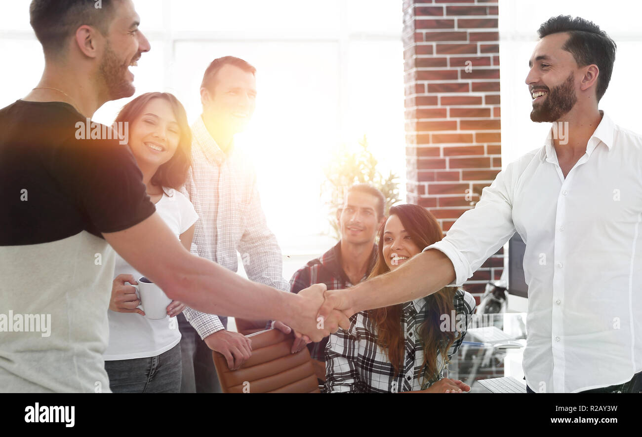 welcome handshake colleagues in creative office Stock Photo - Alamy