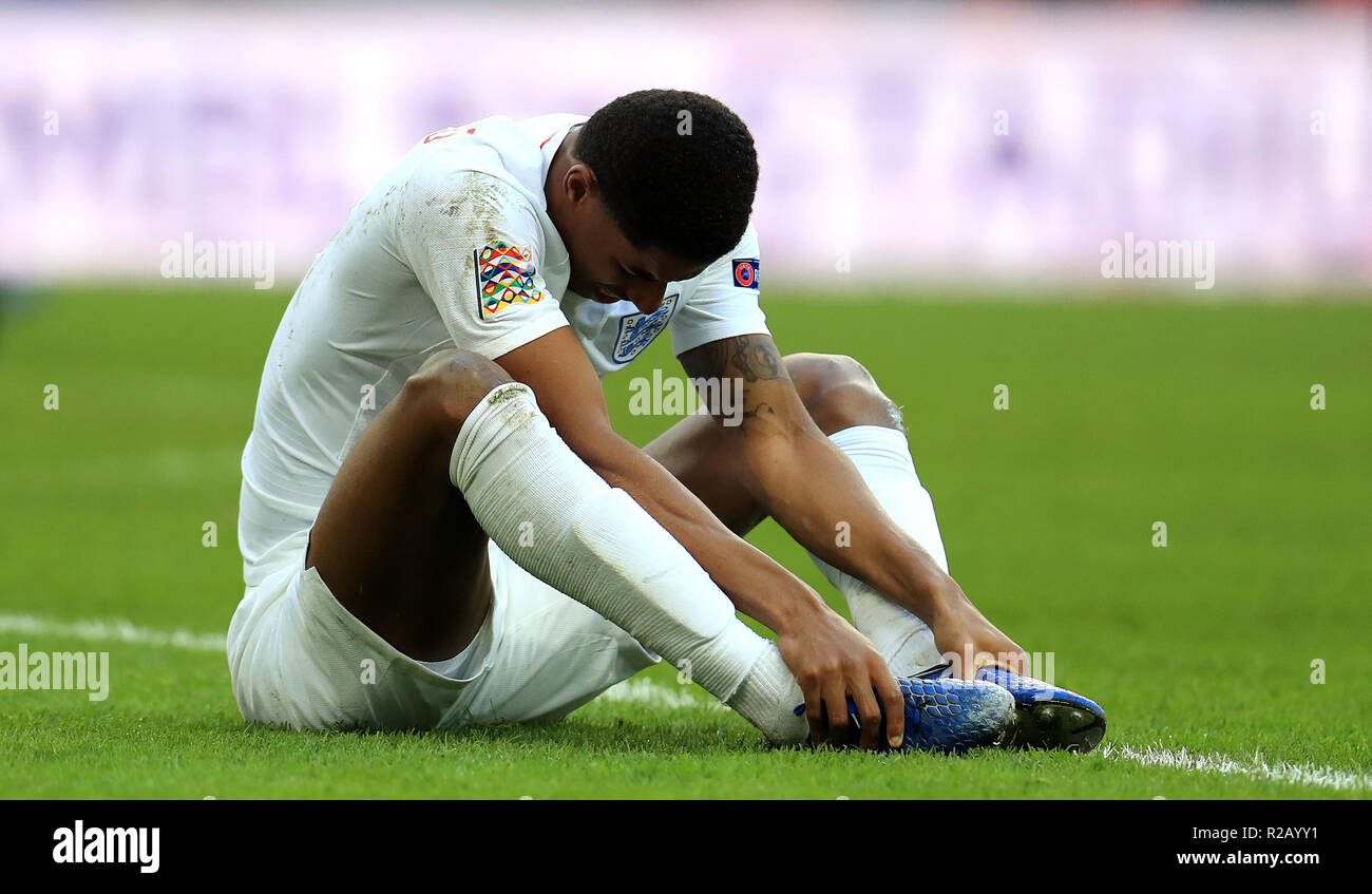 England's Marcus Rashford holds his legs as he sits on the pitch during ...