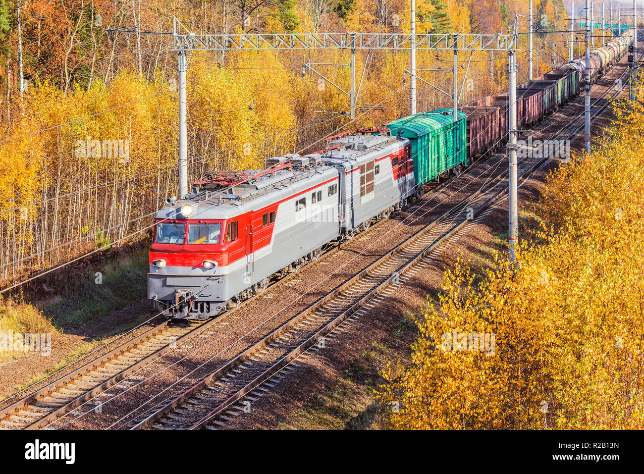 Long freight train approaches to the station at autumn day time Stock ...