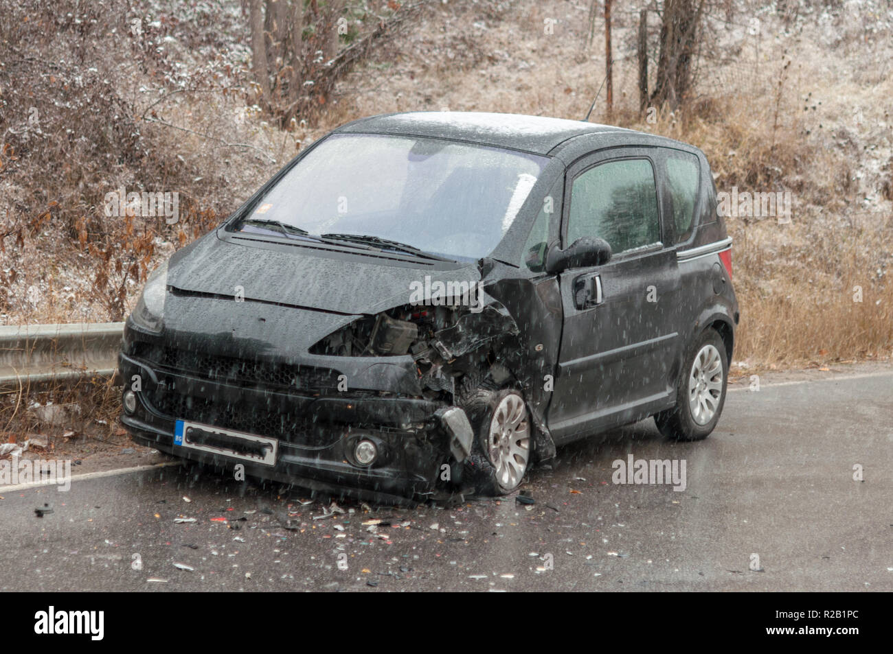 Car accident in the road. Broken car, the engine oil leaked, wheel ...