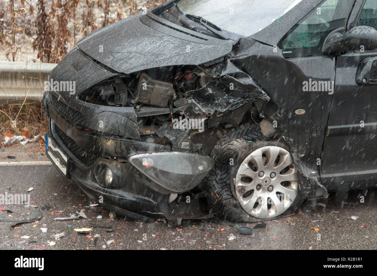 Car accident in the road. Broken car, the engine oil leaked, wheel ...