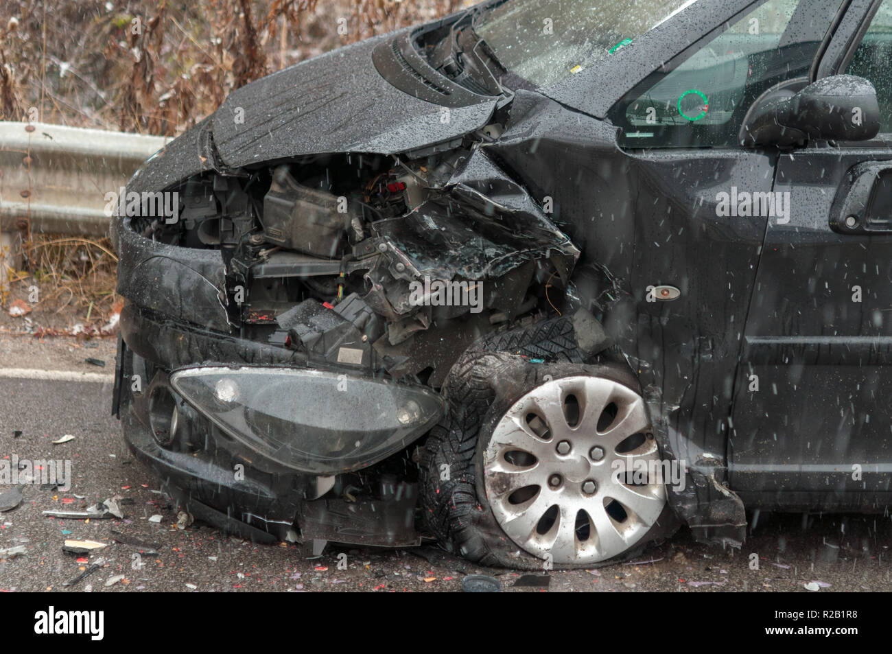 Car accident in the road. Broken car, the engine oil leaked, wheel ...