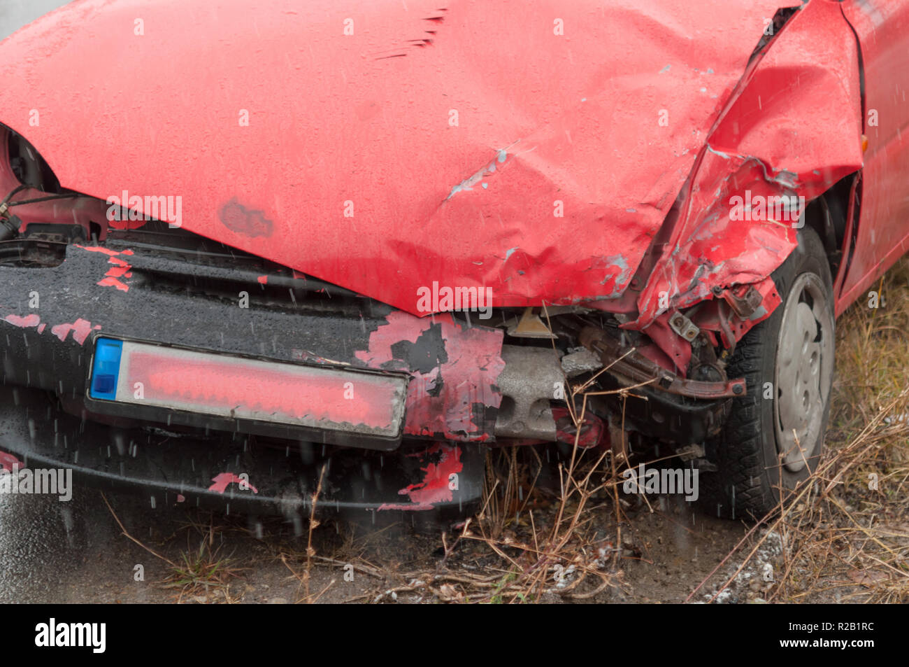 Car accident in the road. Broken car, the engine oil leaked, wheel ...