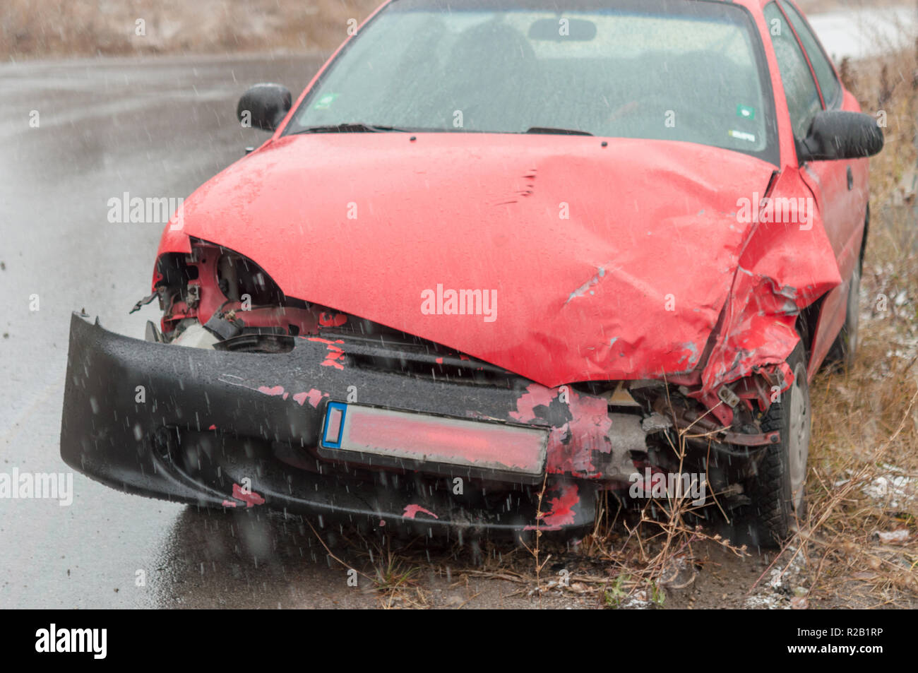 Car accident in the road. Broken car, the engine oil leaked, wheel ...
