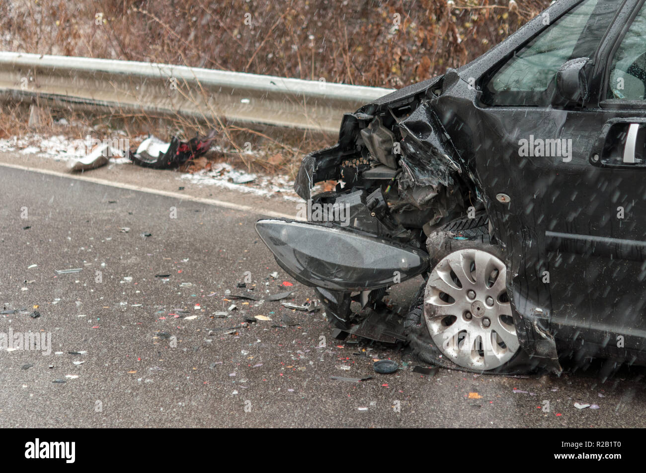 Car accident in the road. Broken car, the engine oil leaked, wheel ...