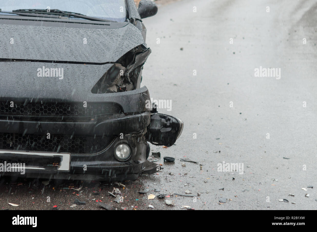 Car accident in the road. Broken car, the engine oil leaked, wheel ...