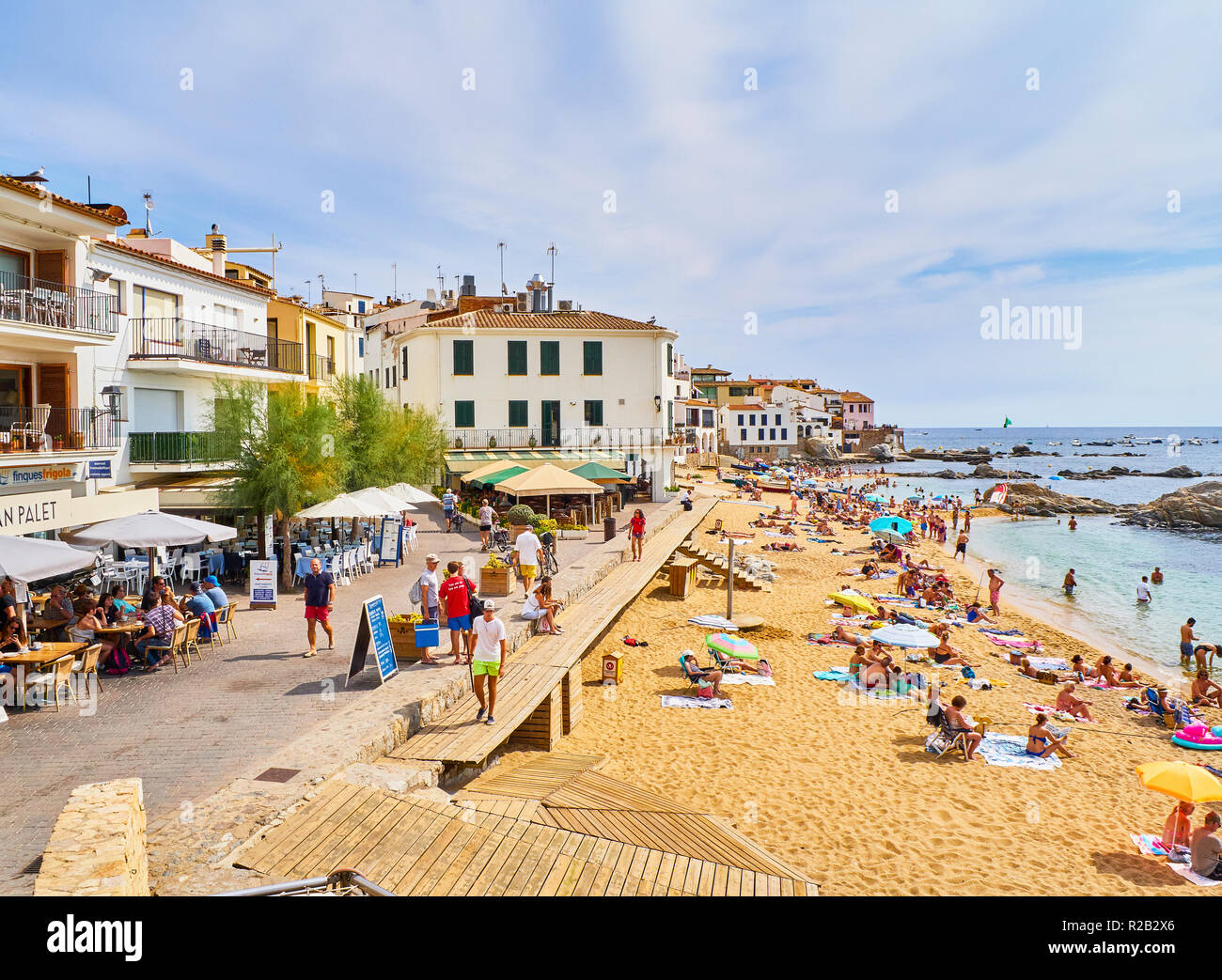 Tourists enjoying a sunbathing in Platja d'En Calau, a beach in Calella ...