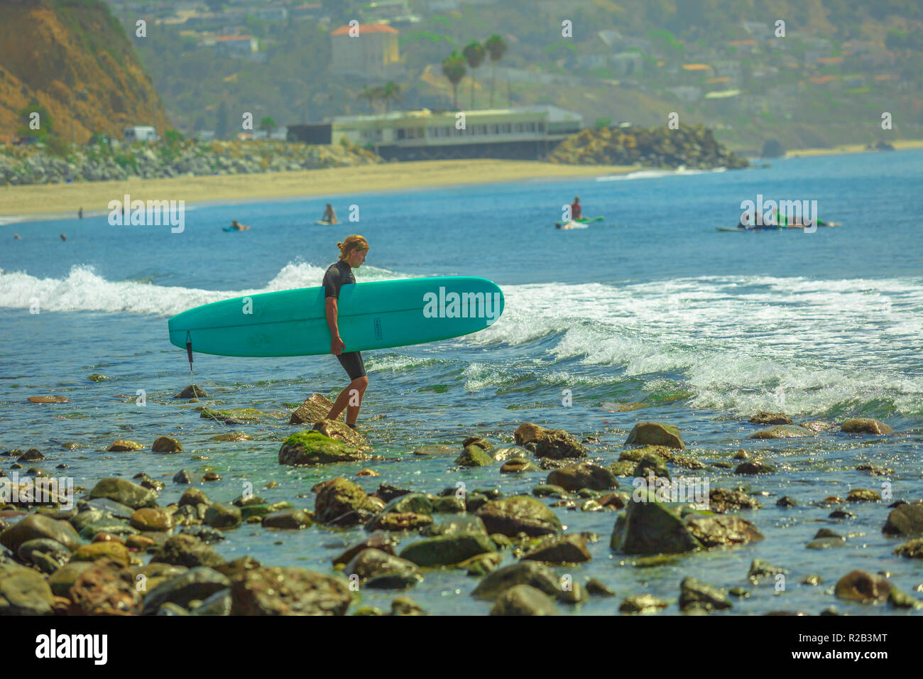 Malibu, California, United States - August 7, 2018: surfer holds ...