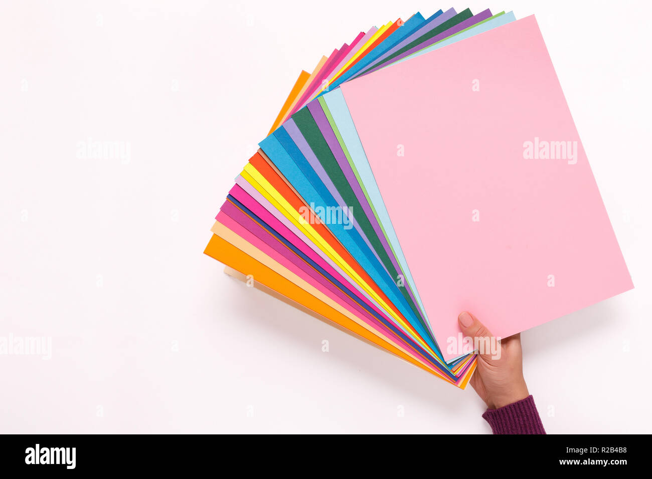 woman hand holding sheets of different colored paper Stock Photo - Alamy