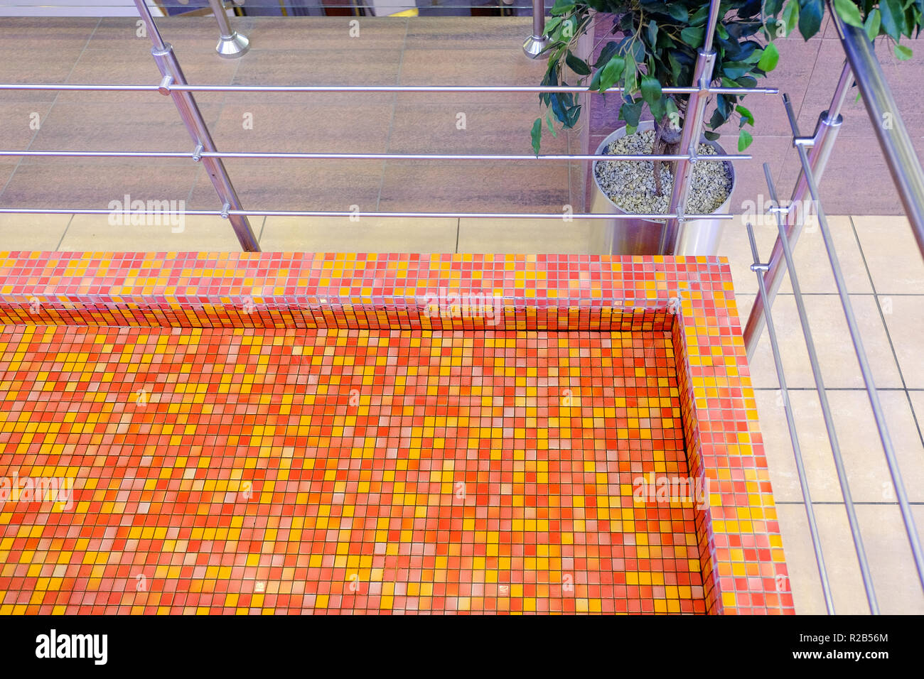 water in the pool with red-orange decorative tiles Stock Photo - Alamy