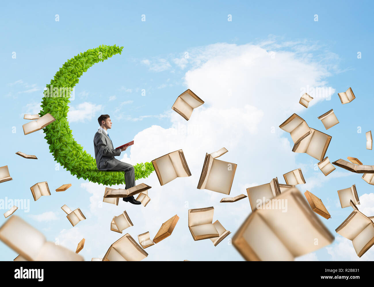 Man reading book and many of them flying in air Stock Photo - Alamy