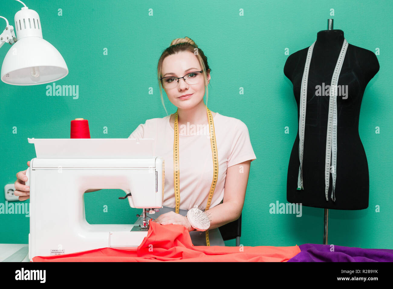 Sewing workshop. Seamstress at work. Young woman working with sewing ...
