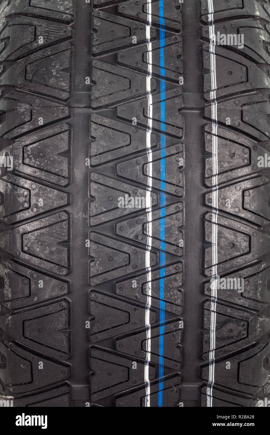 The surface of a new car tire close up, isolated on a white background ...