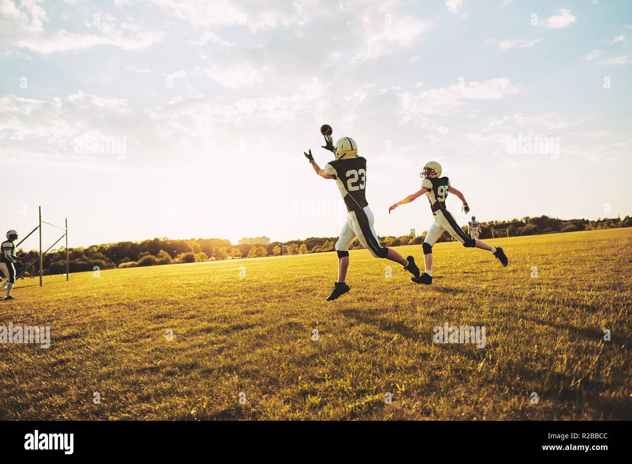 American football player making a reception during team practice drills ...