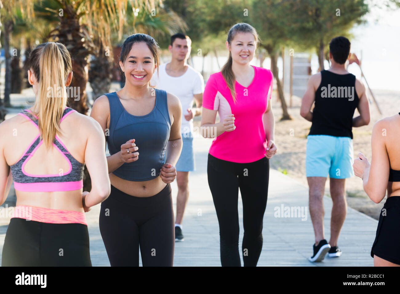 Active smiling people during running training in daytime Stock Photo ...