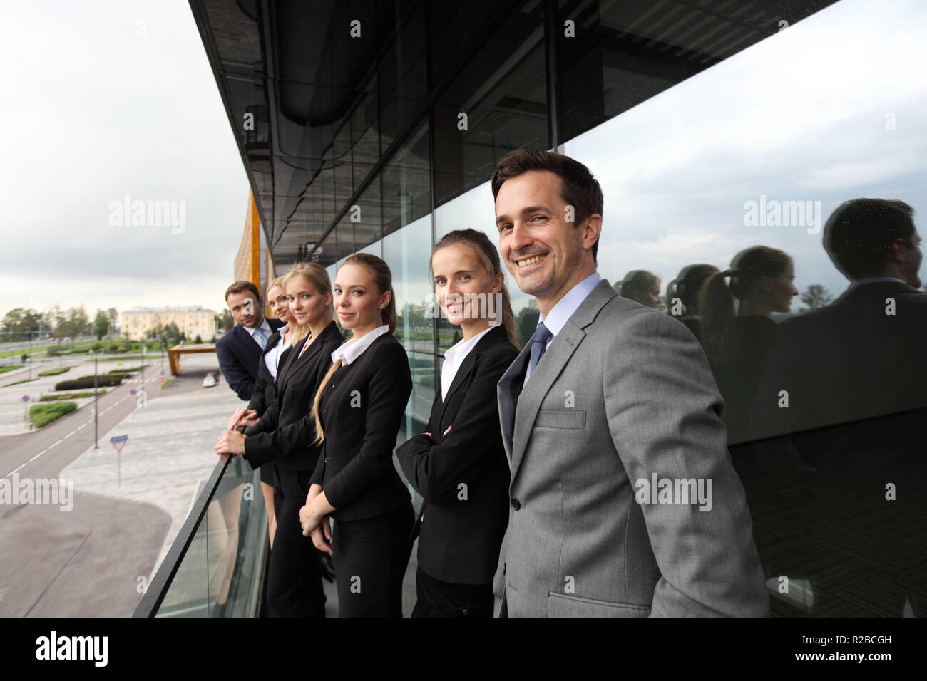 Business people team standing in a row at the balcony of modern office ...
