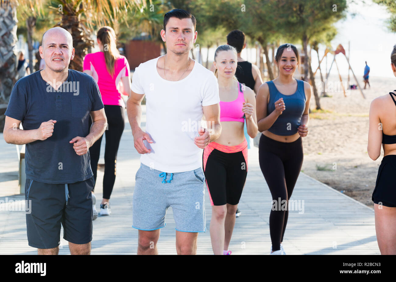 Active smiling people during running training in daytime Stock Photo ...