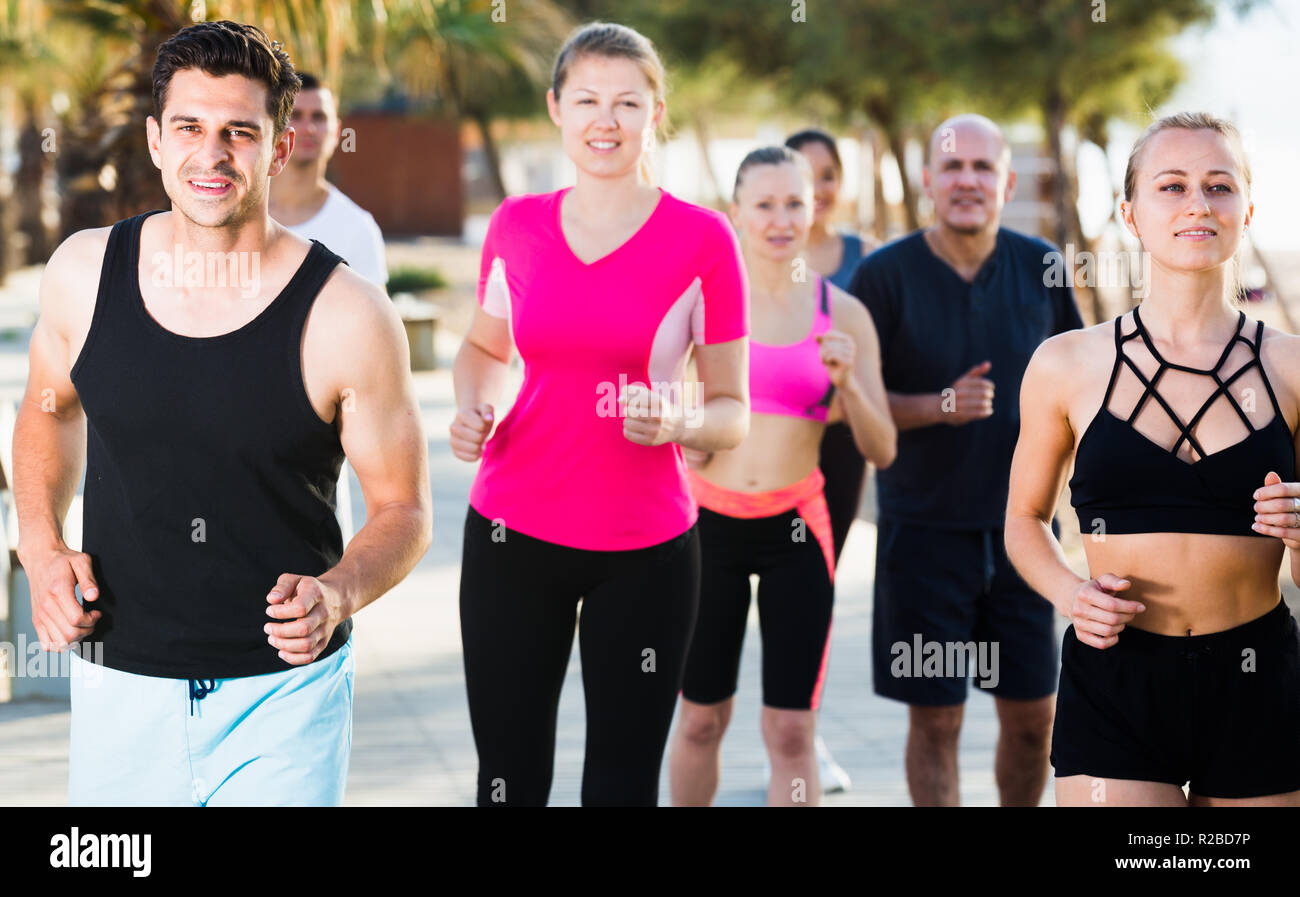 Active smiling people during running training in daytime Stock Photo ...