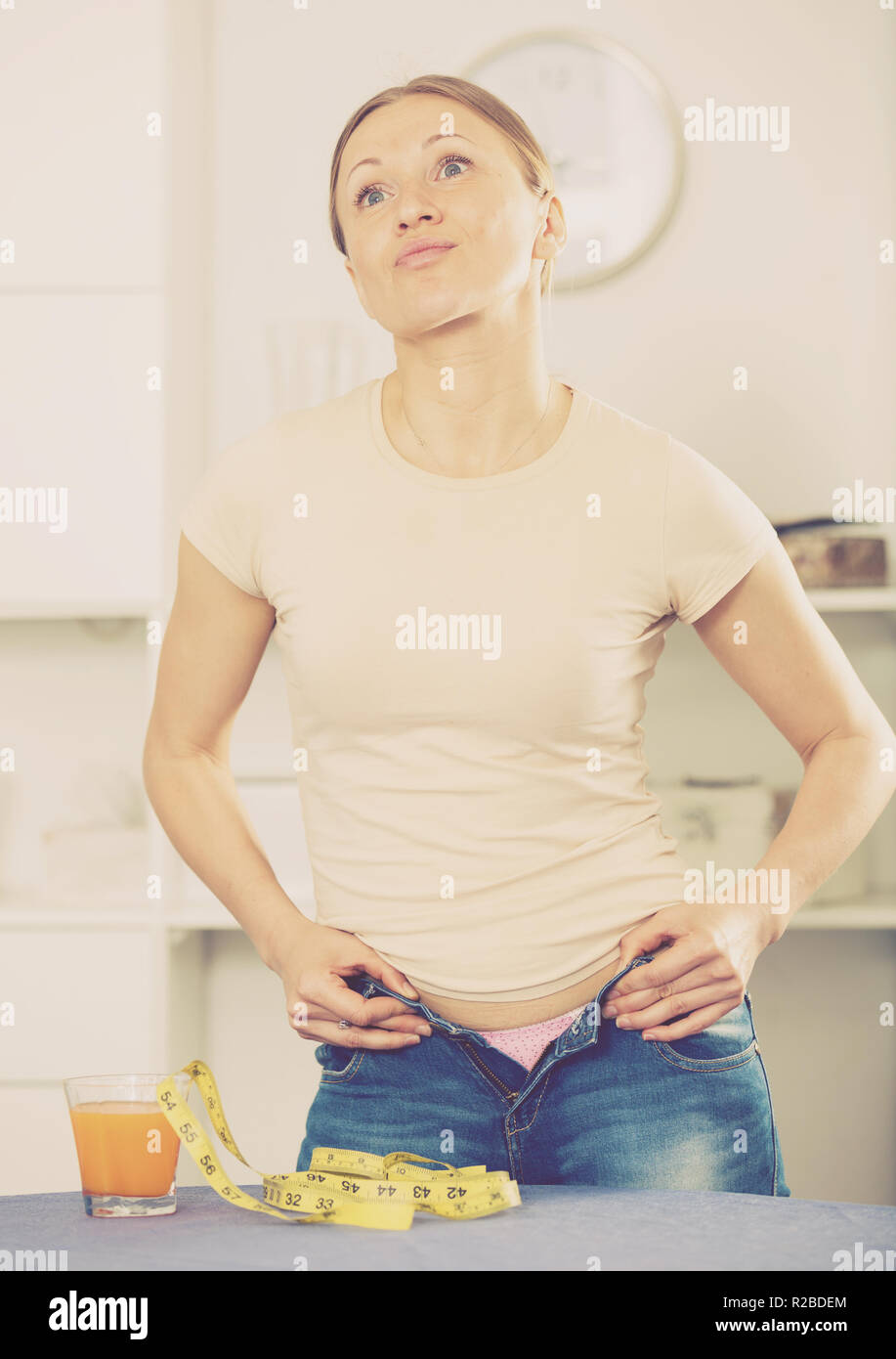 Woman weight gain jeans hi-res stock photography and images - Alamy