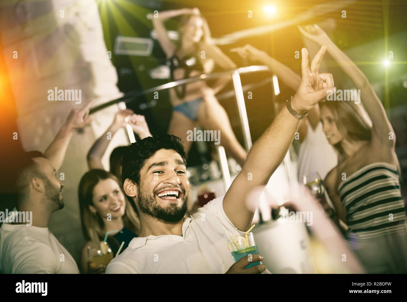 Happy cheerful positive male joying and thumbs up on party in the club ...