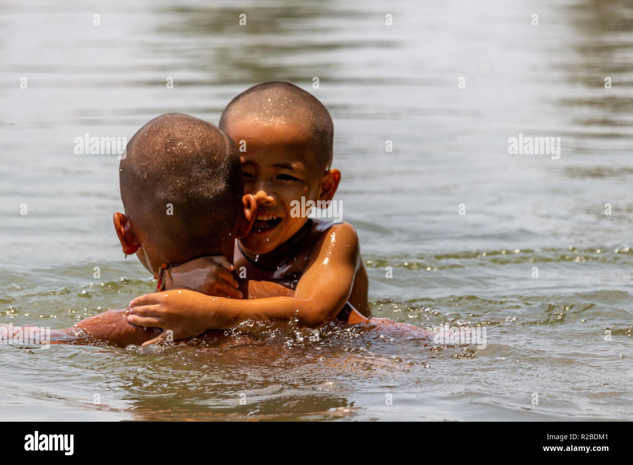 Kids Swimming In A River