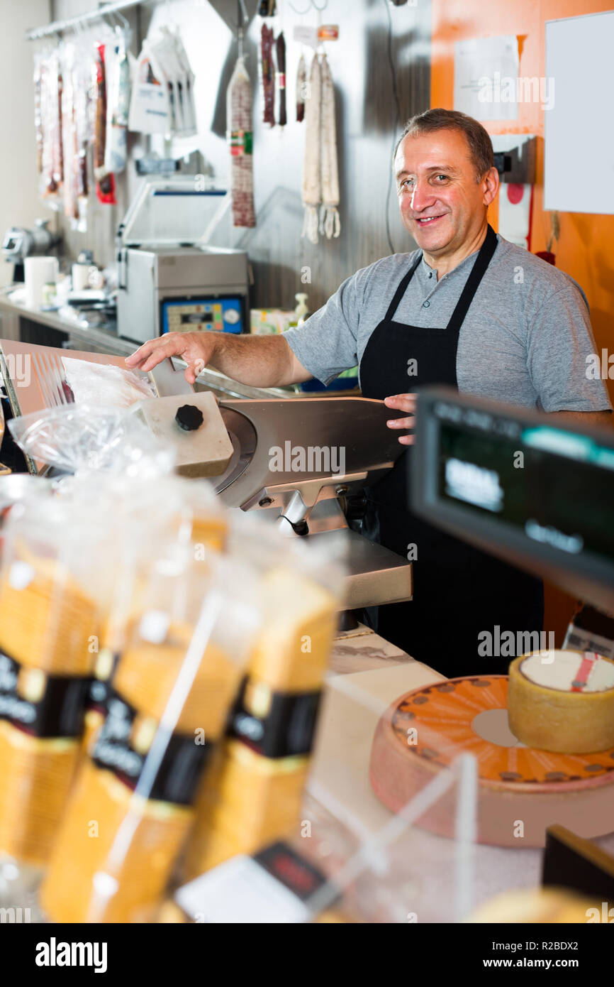 american man standing near counter with assortment of grocery products ...
