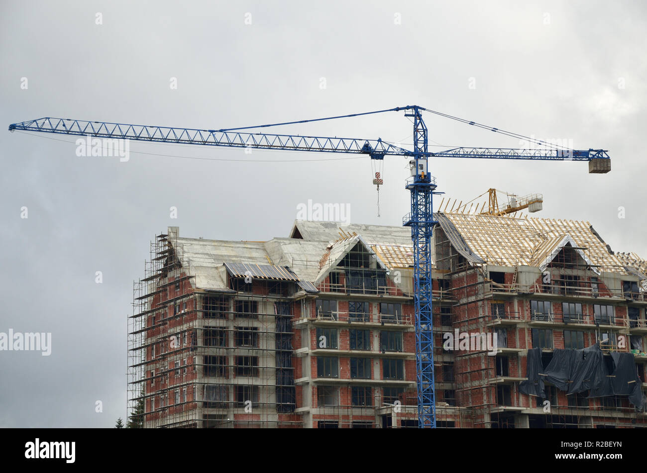 Building under construction with a crane Stock Photo - Alamy