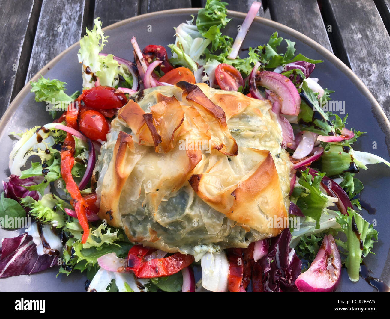 Greek pie Spankopita with salad Stock Photo - Alamy
