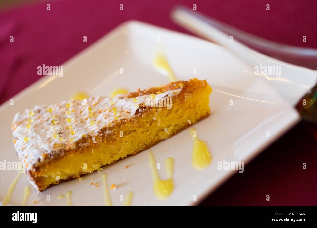 Piece of traditional Spanish almond cake Tarta de Santiago on white ...