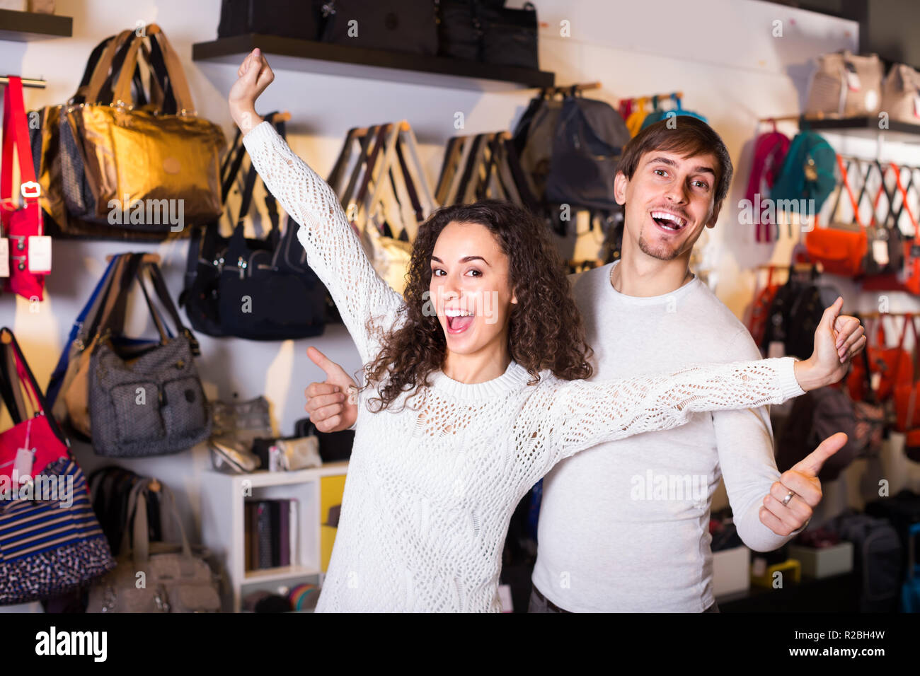 Portrait of excited young customers in store of handbags Stock Photo ...