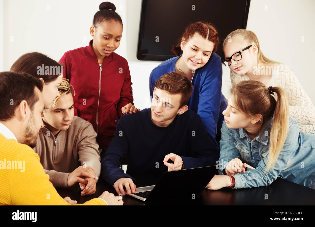 Positive students working at important project during school day Stock ...