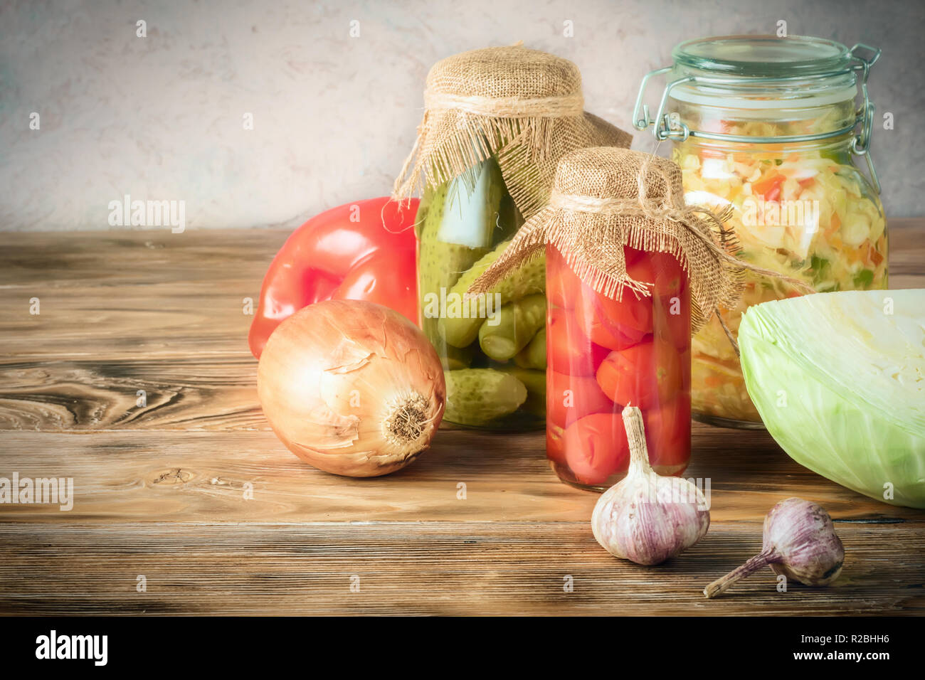 Set of fermented vegetables in jars on wooden rustic table. Cabbage ...