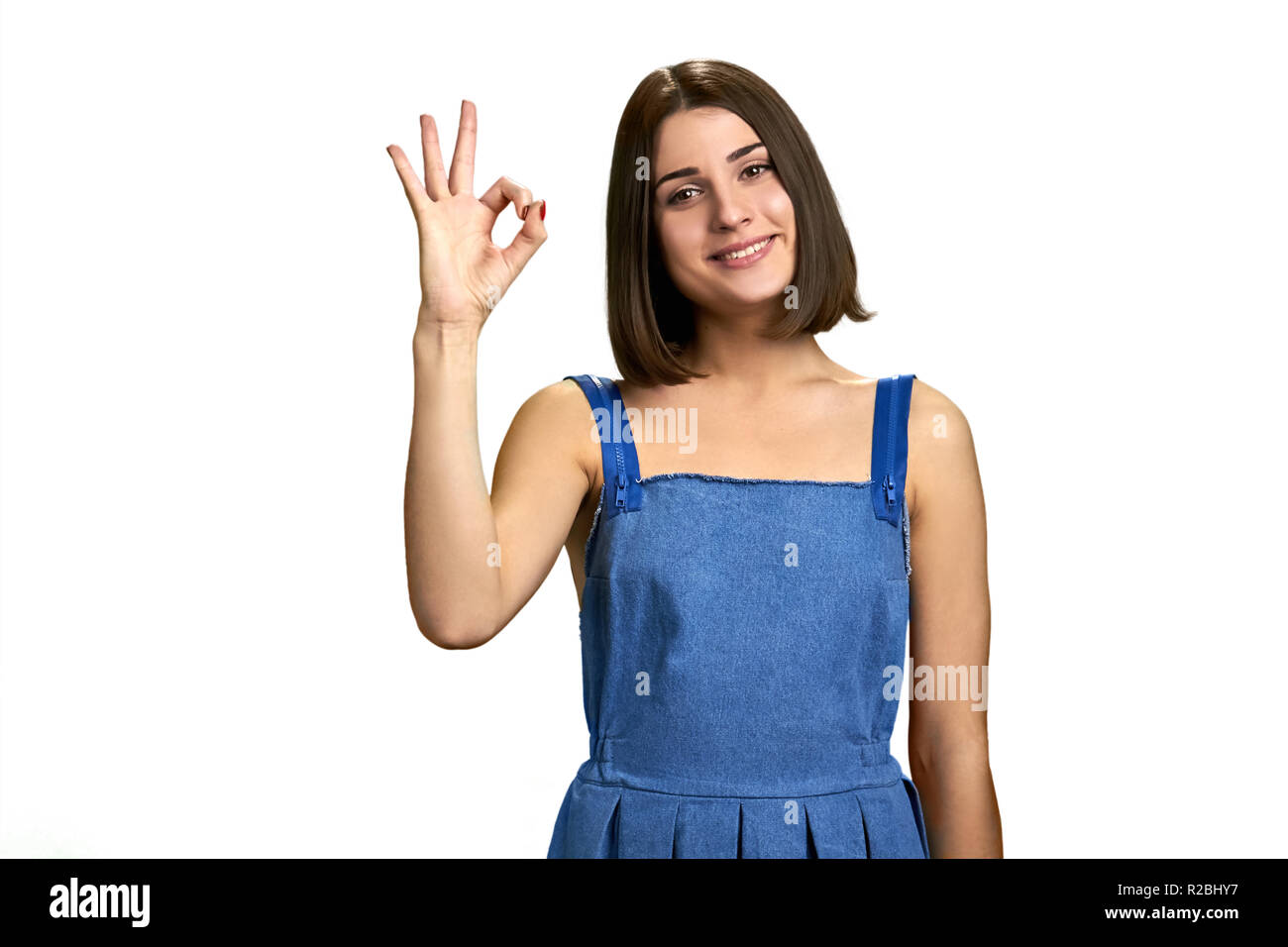 Pretty girl showing OK gesture. Portrait of young happy woman gesturing ...