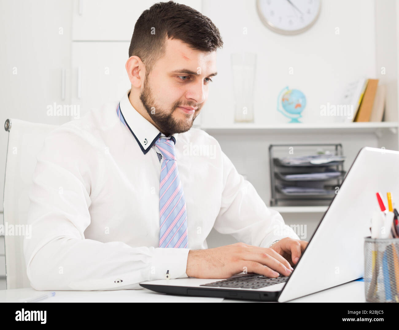 Male employee having productive day at work in office Stock Photo - Alamy